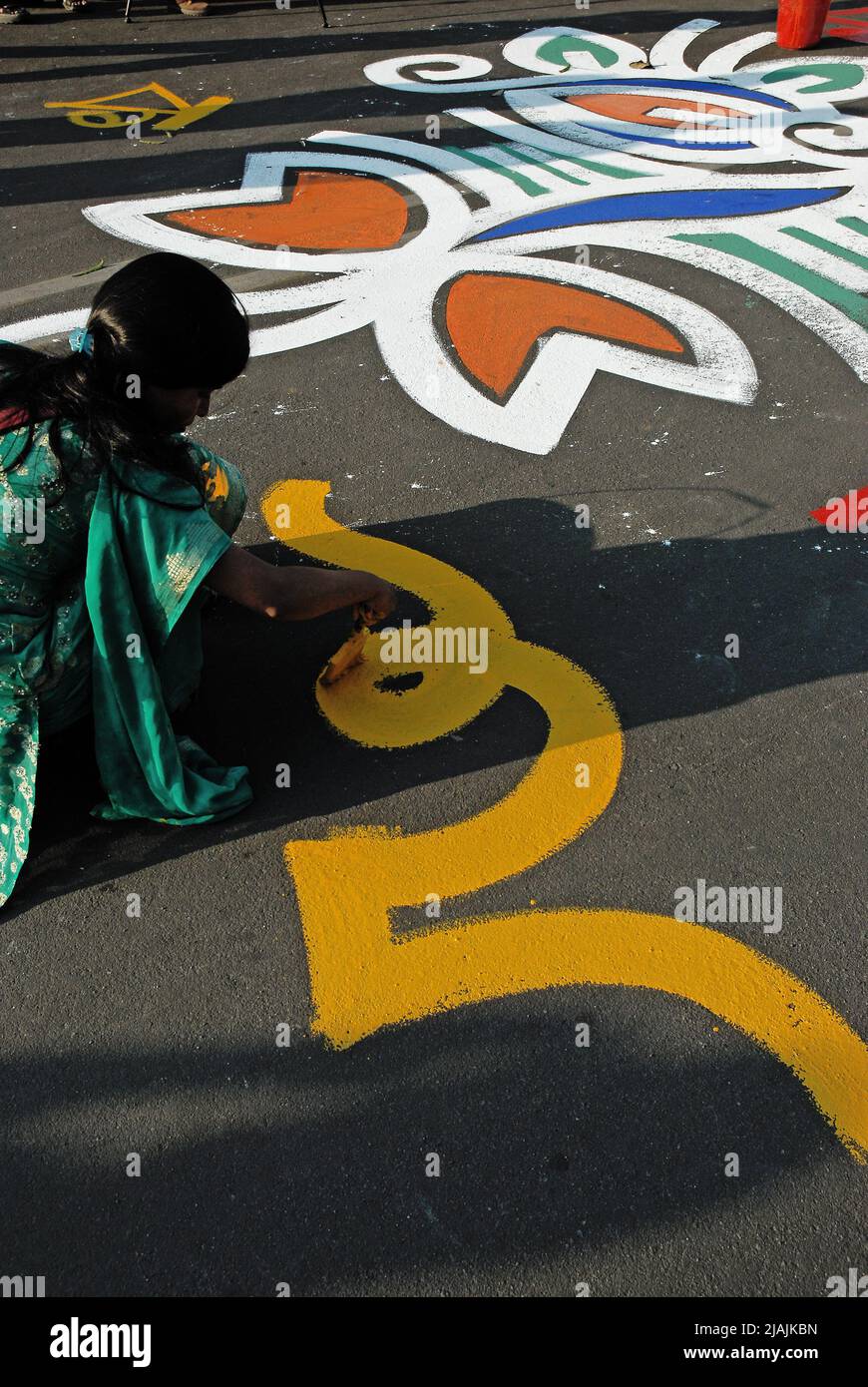 Students of the Institute of Fine Arts paint alpona (color designs) on ...