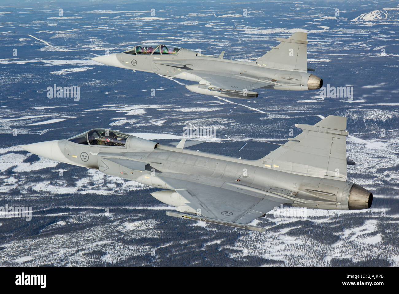 A pair of Swedish Air Force JAS-39 Gripen fighter jets in flight over ...