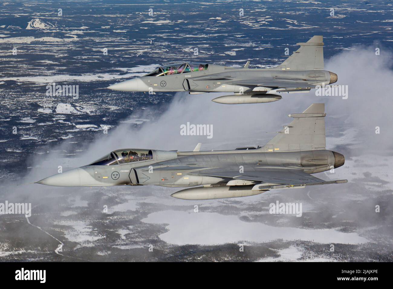 A pair of Swedish Air Force JAS-39 Gripen fighter jets in flight over ...