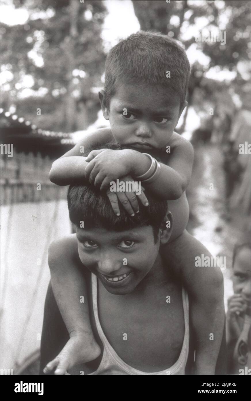 A caretaker boy carries his younger brother on his shoulder. Rohinga ...