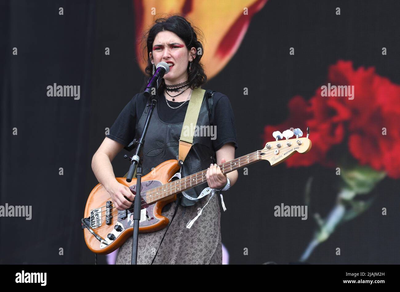 Bass guitarist and singer Ade Martin is shown performing on stage ...