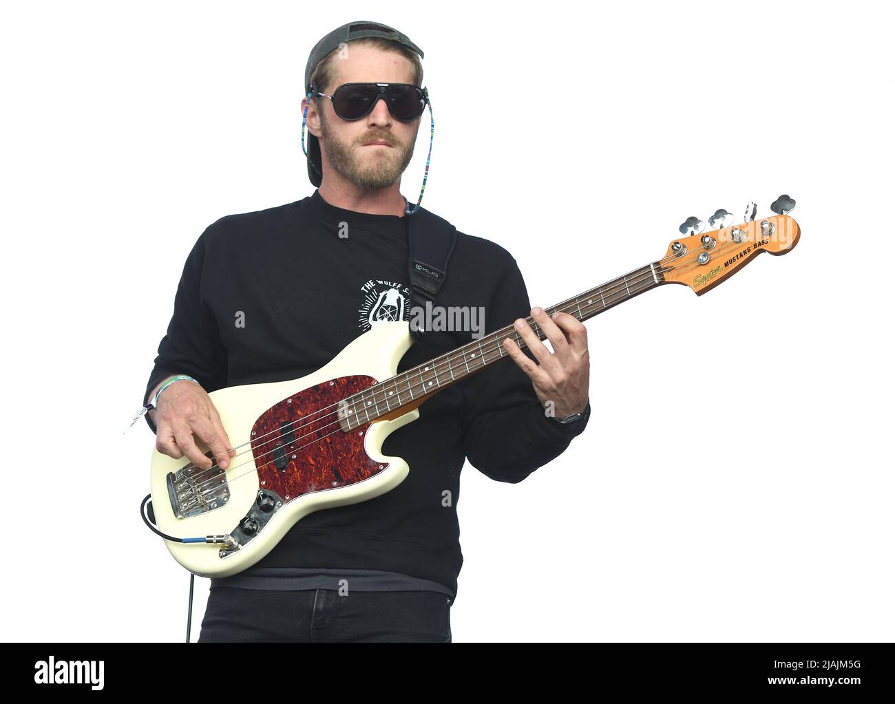 The bass guitarist in the Julie Rhodes band is shown performing on ...