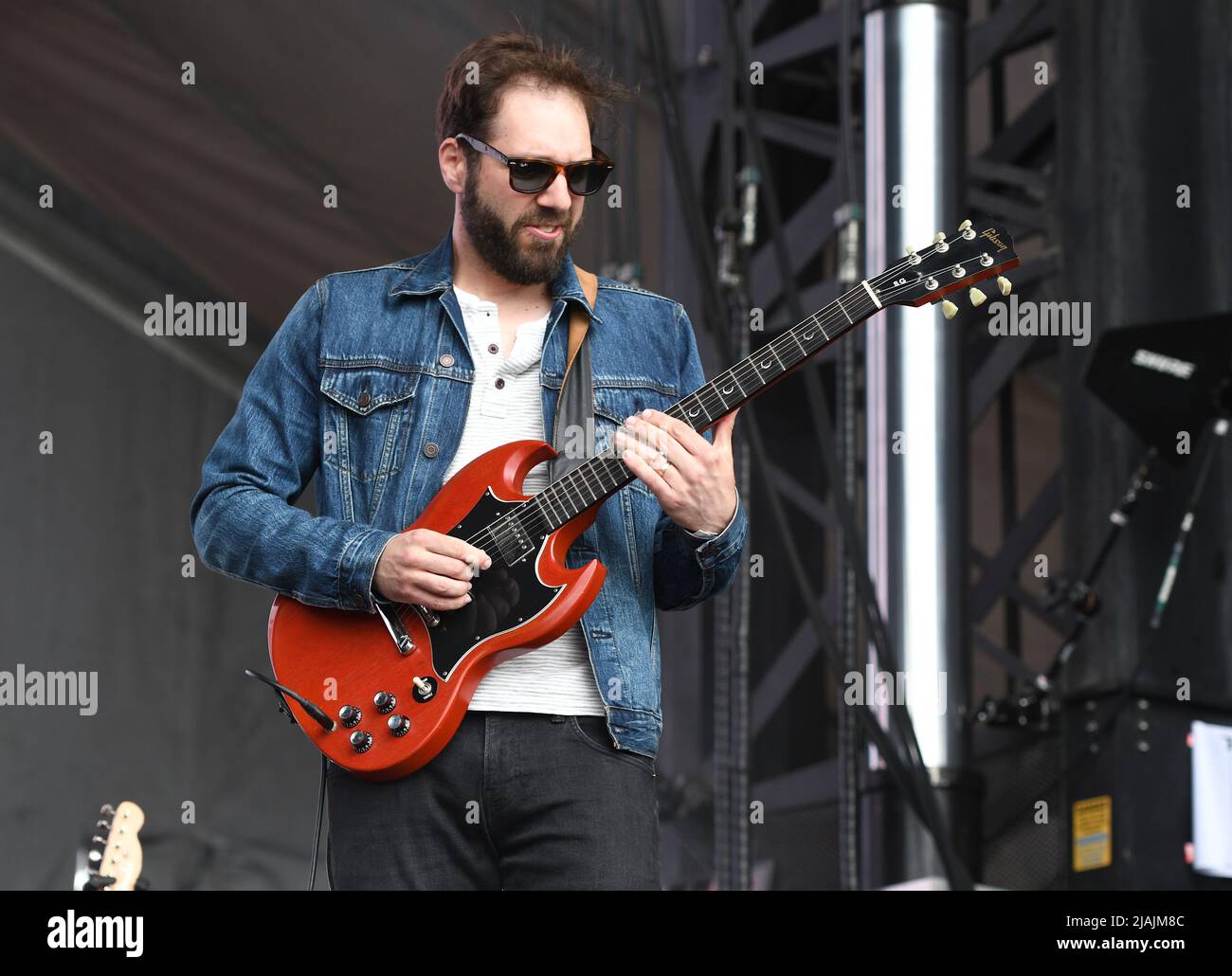 The lead guitarist in the Julie Rhodes band is shown performing on ...