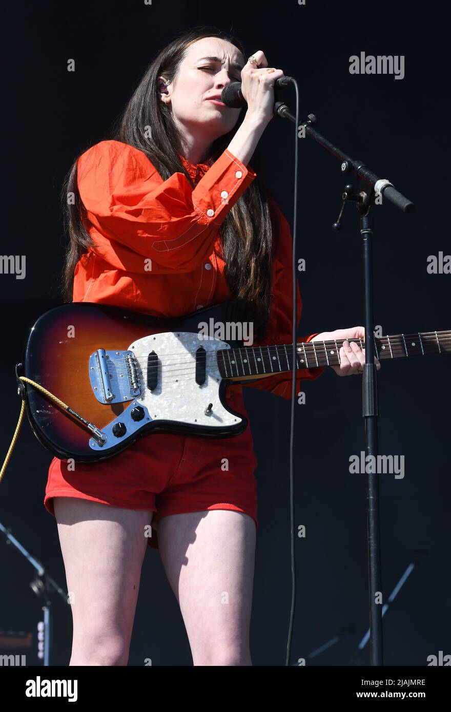 Singer Madeline Follin is shown performing on stage during a live ...