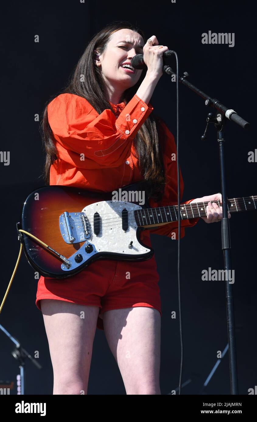 Singer Madeline Follin is shown performing on stage during a live ...
