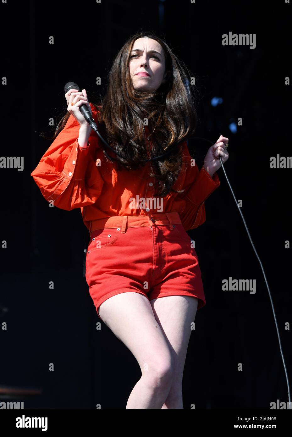 Singer Madeline Follin is shown performing on stage during a live ...