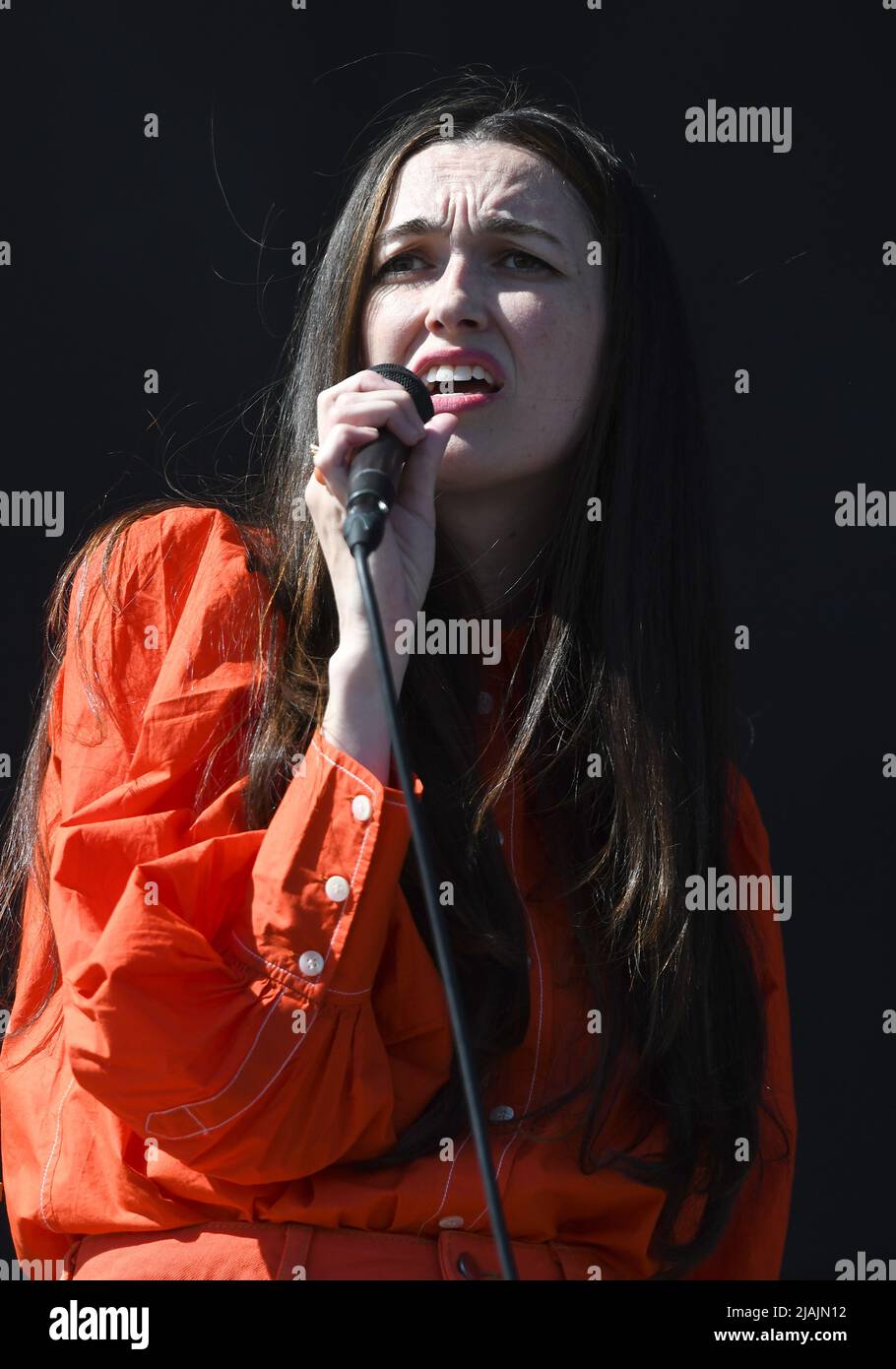 Singer Madeline Follin is shown performing on stage during a live ...