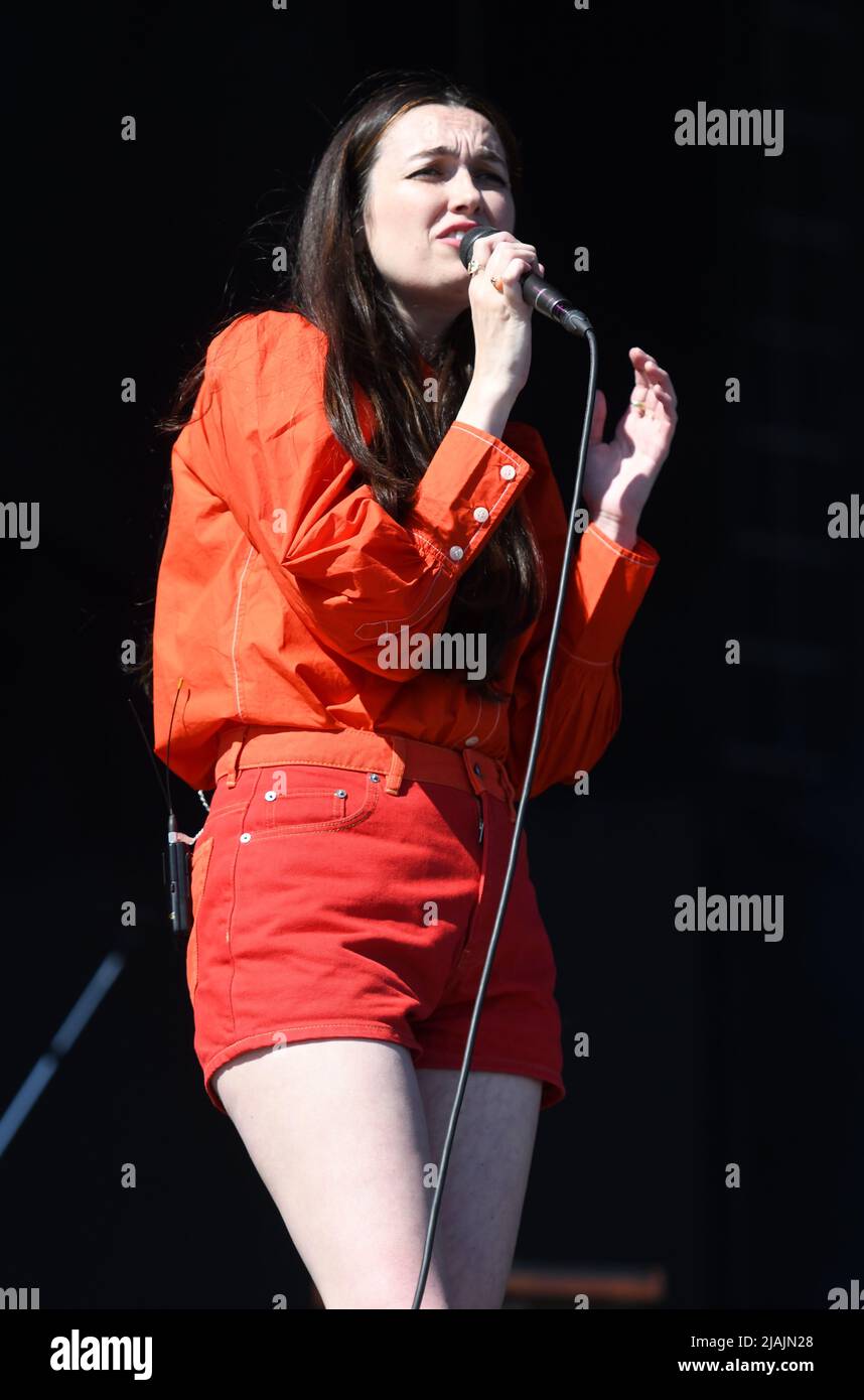 Singer Madeline Follin is shown performing on stage during a live ...