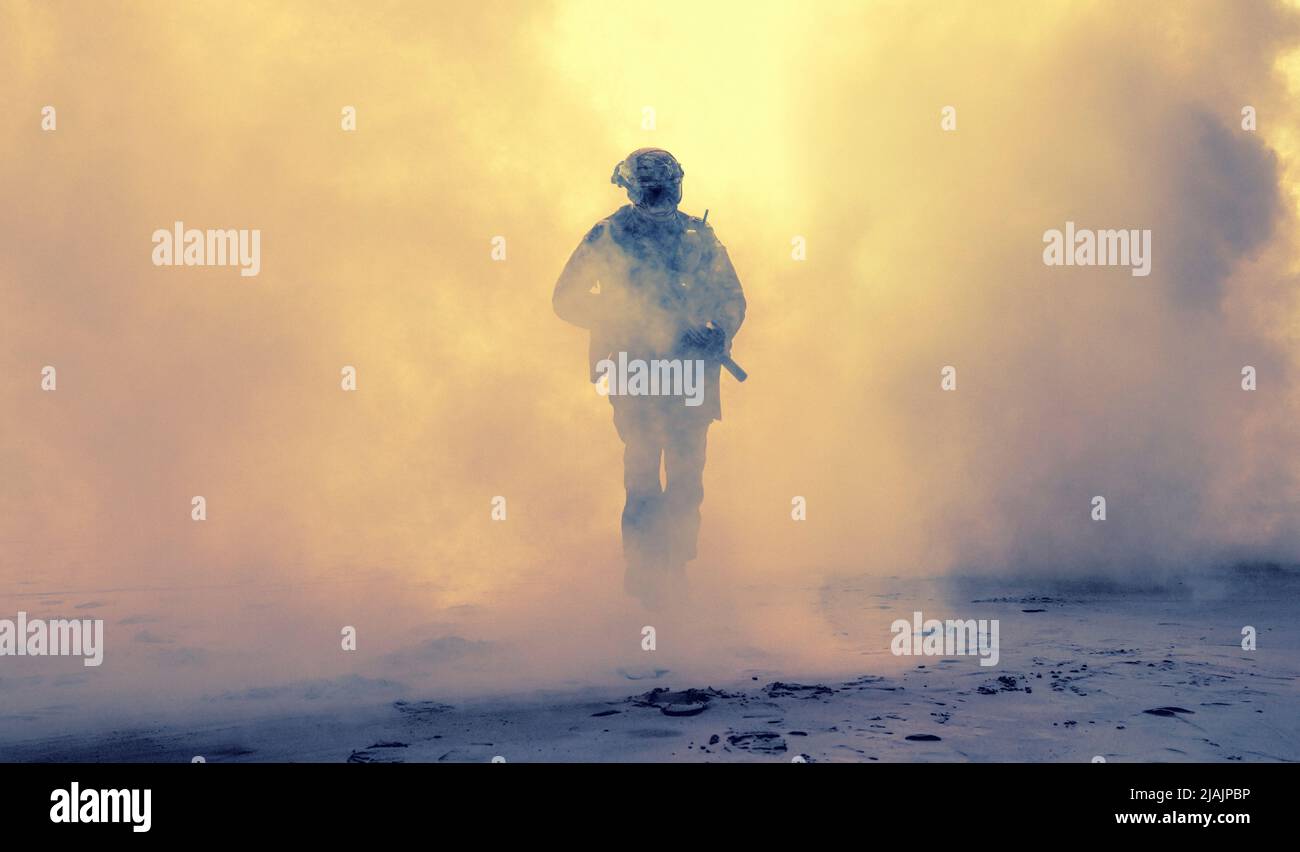 Special operations forces soldier walking through a battlefield covered ...