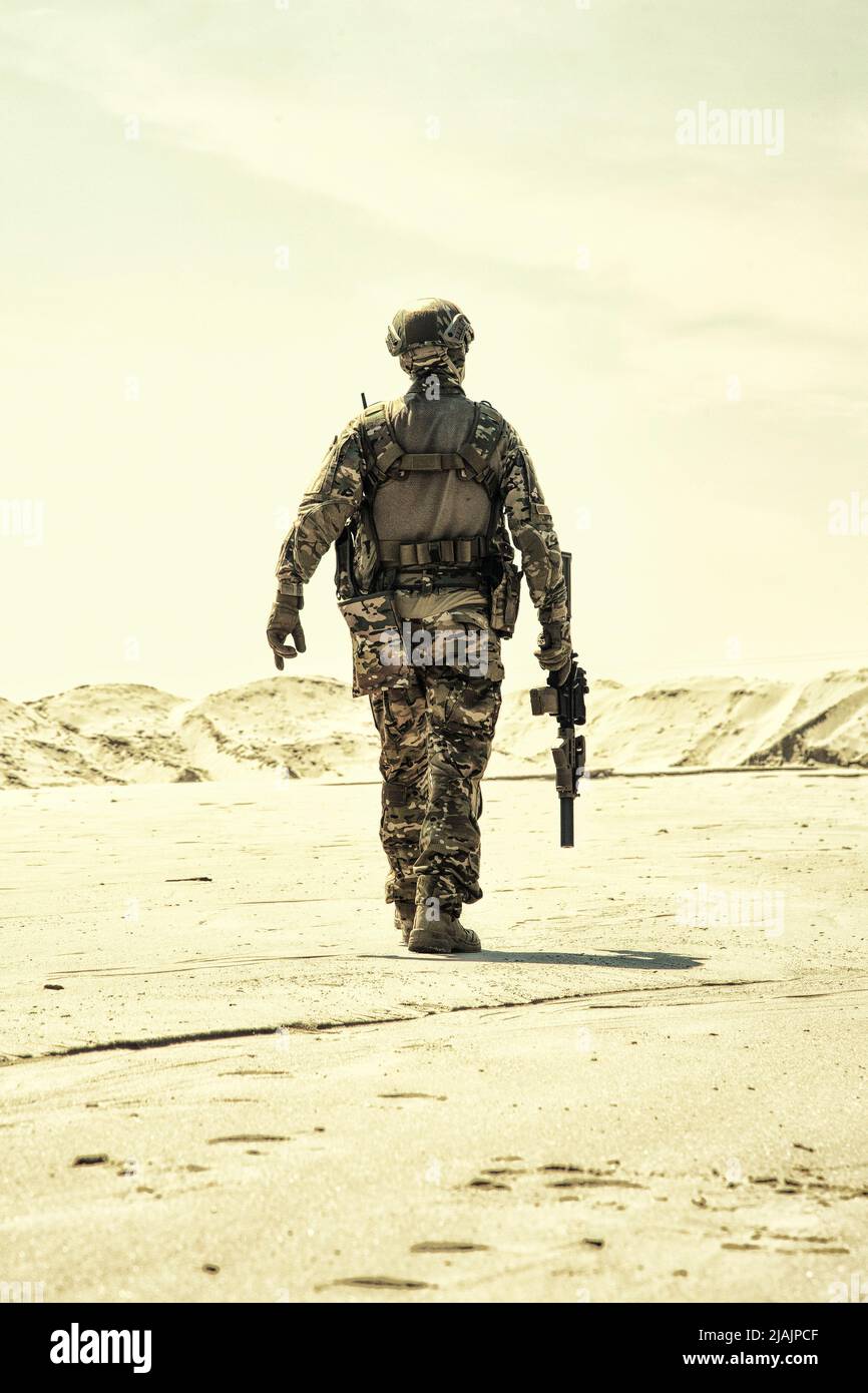 Desatured photo of a military contractor patrolling desert territory ...