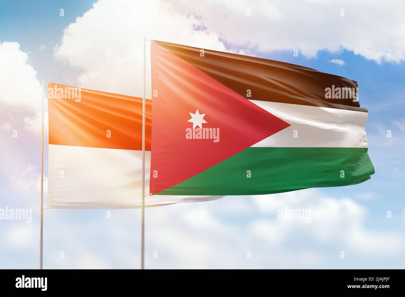 Sunny blue sky and flags of jordan and indonesia Stock Photo - Alamy