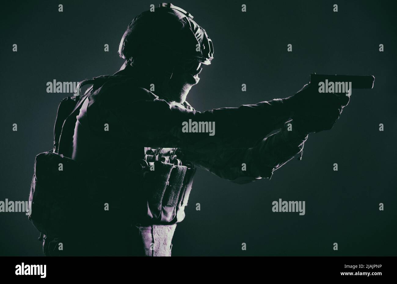 Elite forces soldier wearing mask, helmet and load carriage system ...