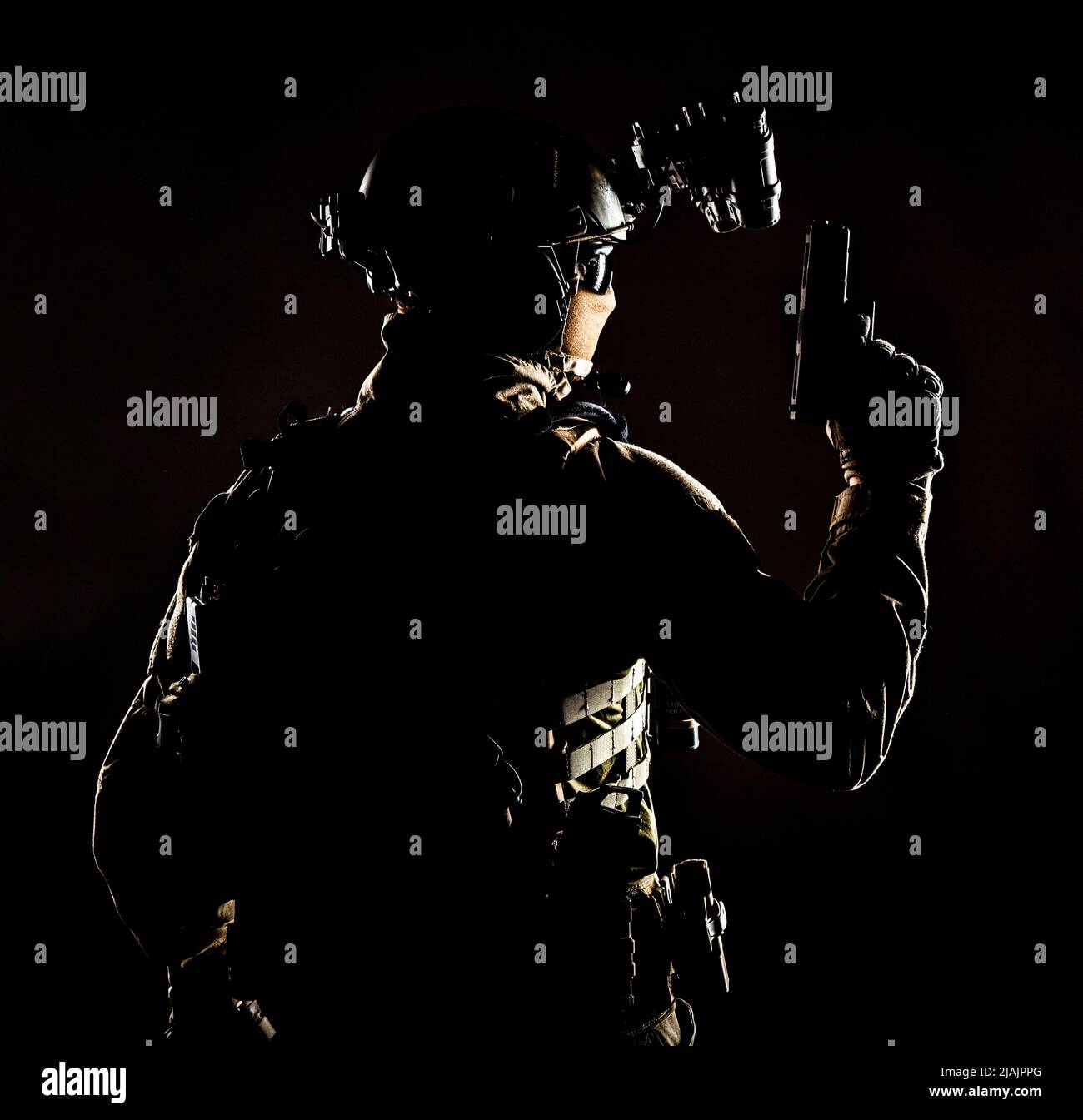 Low key studio shot of a special forces soldier on secret night mission ...