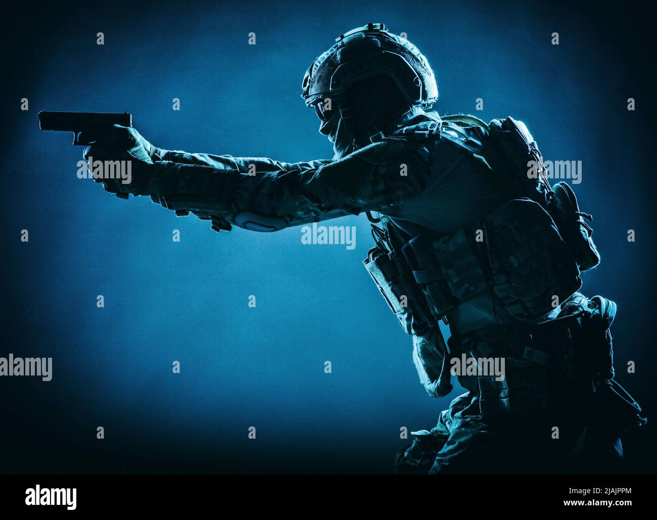 Elite forces soldier wearing mask, helmet and load carriage system ...