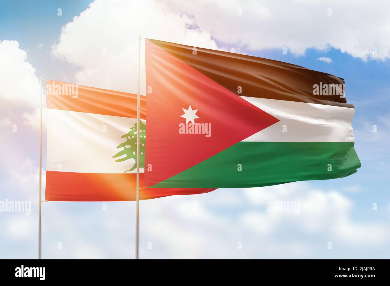 Sunny blue sky and flags of jordan and lebanon Stock Photo - Alamy