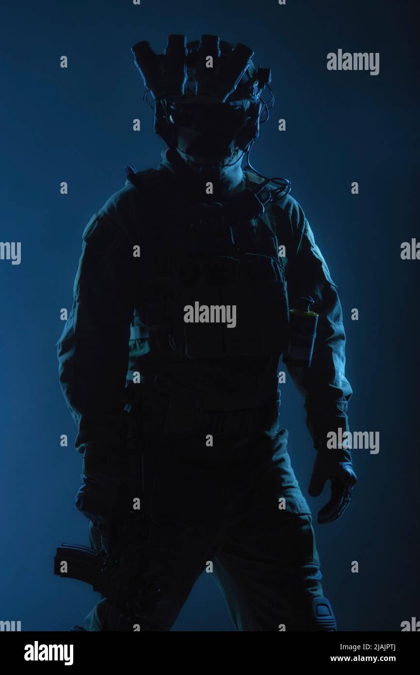 Soldier equipped with night vision device on helmet, standing with ...