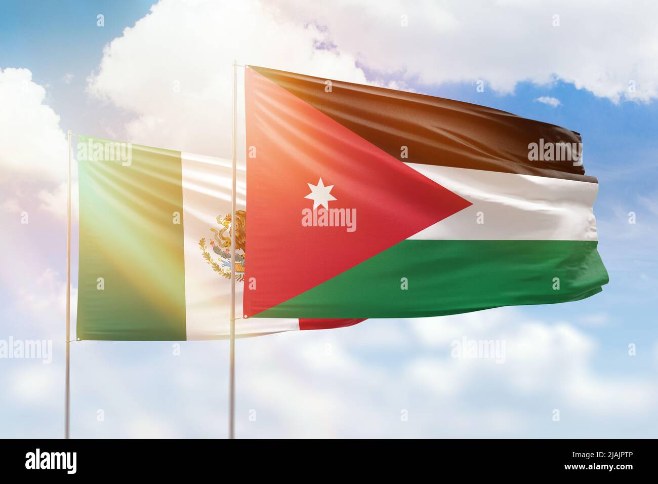 Sunny blue sky and flags of jordan and mexico Stock Photo - Alamy