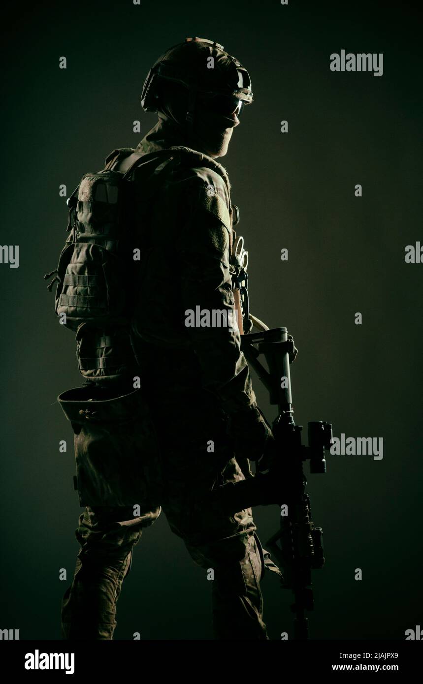 Low key studio shot of Army special forces soldier in tactical helmet ...