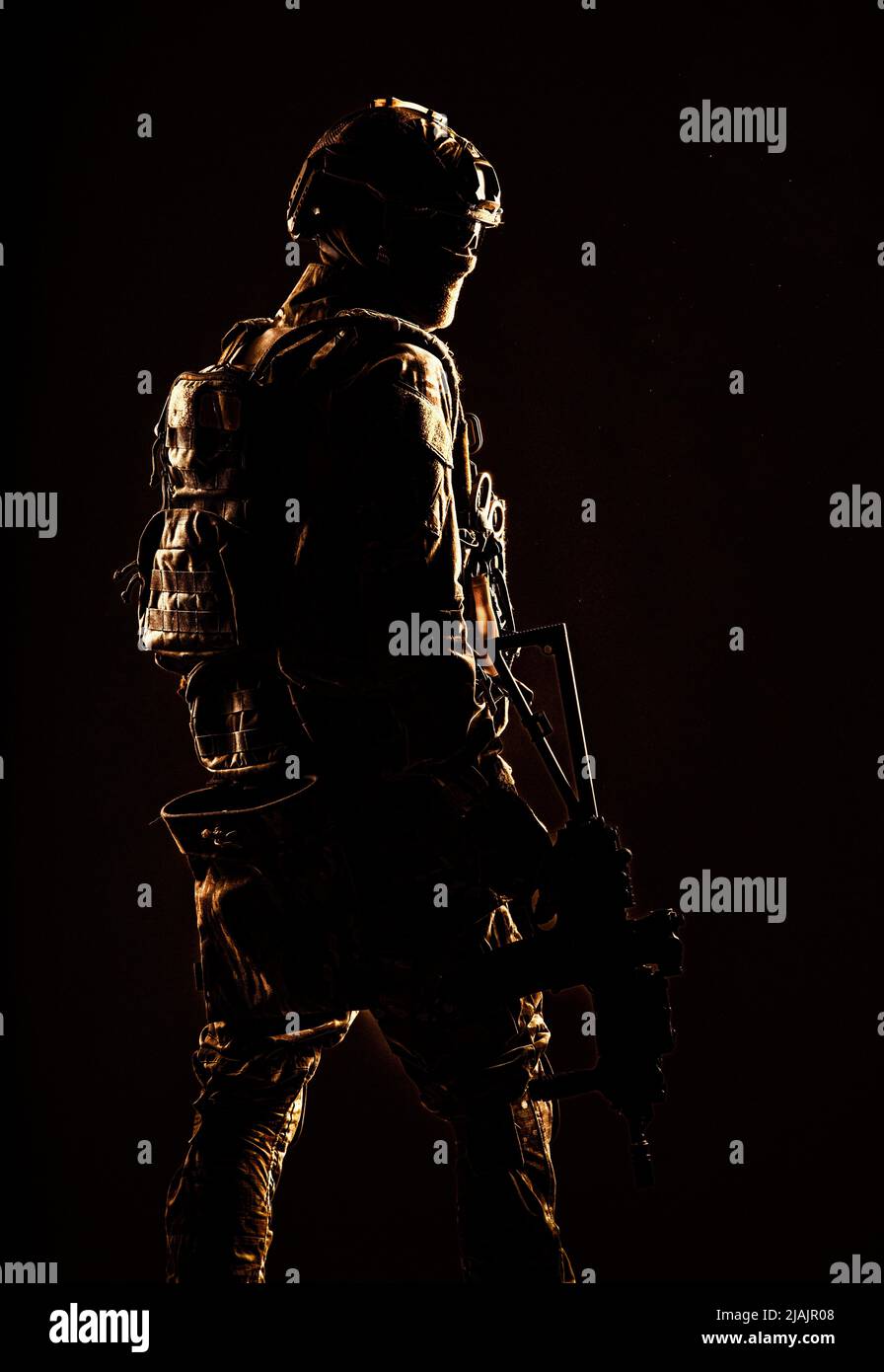Low key studio shot of Army special forces soldier in tactical helmet ...
