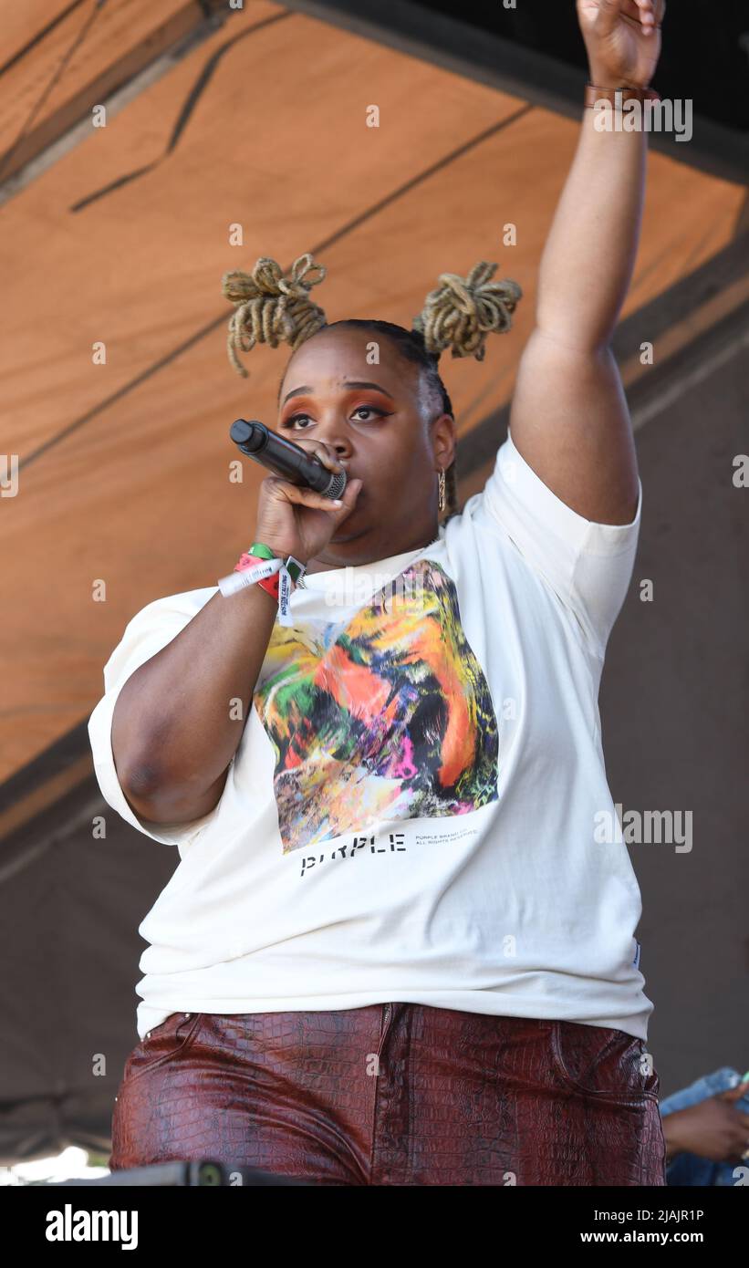 Poet, rapper, and educator, Oompa is shown performing on stage during a ...