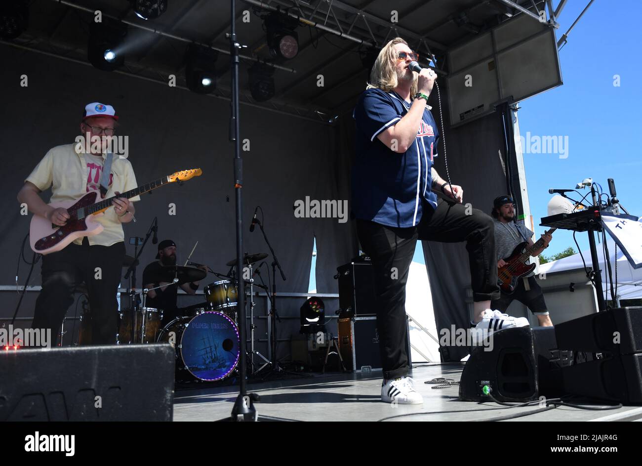 The Paper Tigers are shown performing on stage during a live concert ...