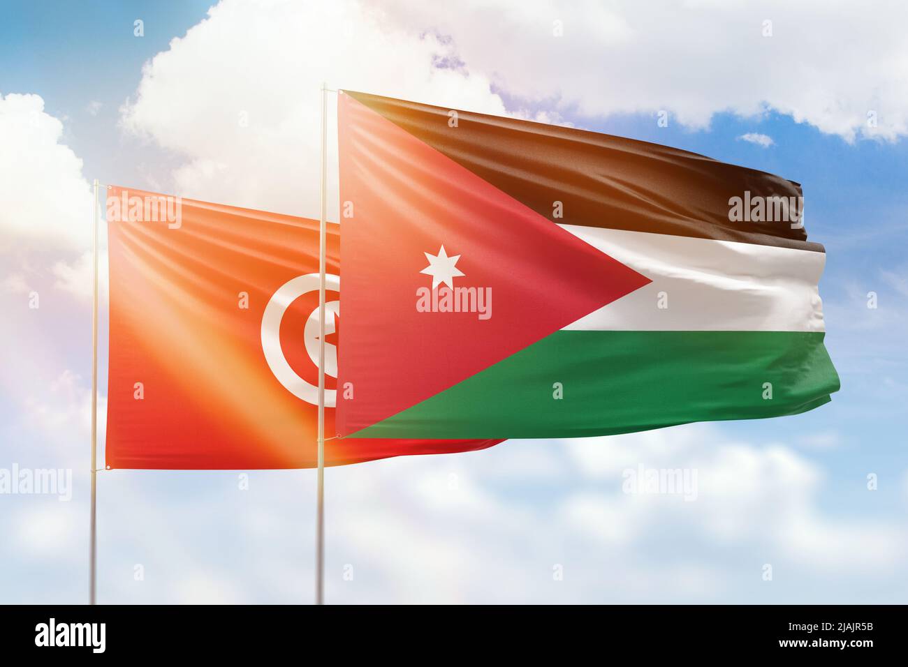 Sunny blue sky and flags of jordan and tunisia Stock Photo - Alamy