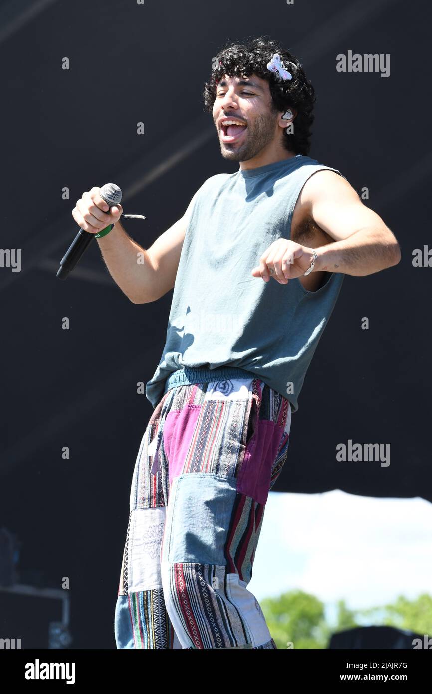 Singer Isaac Pech is shown performing on stage during a live concert ...