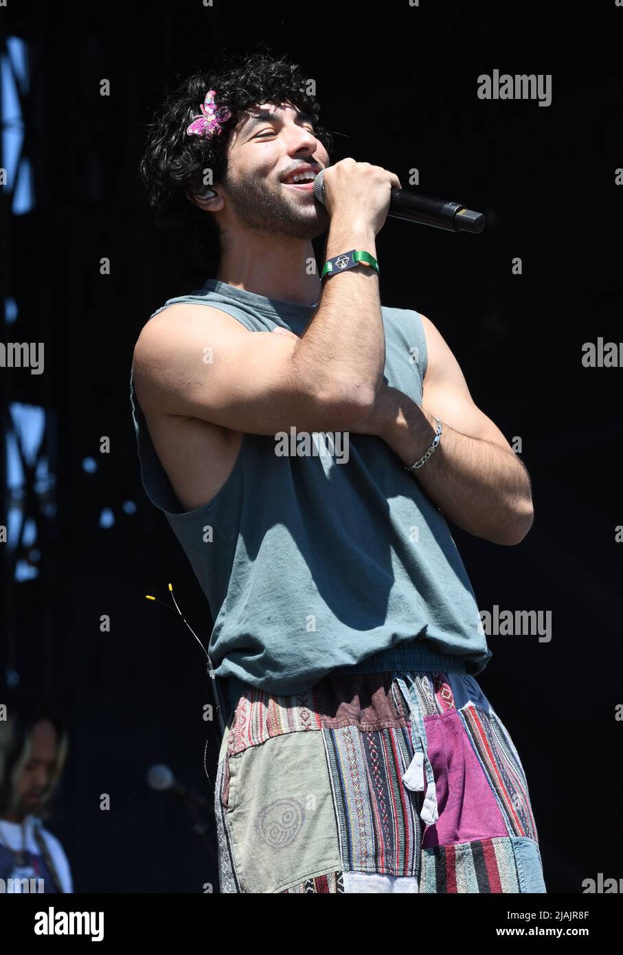 Singer Isaac Pech is shown performing on stage during a live concert ...