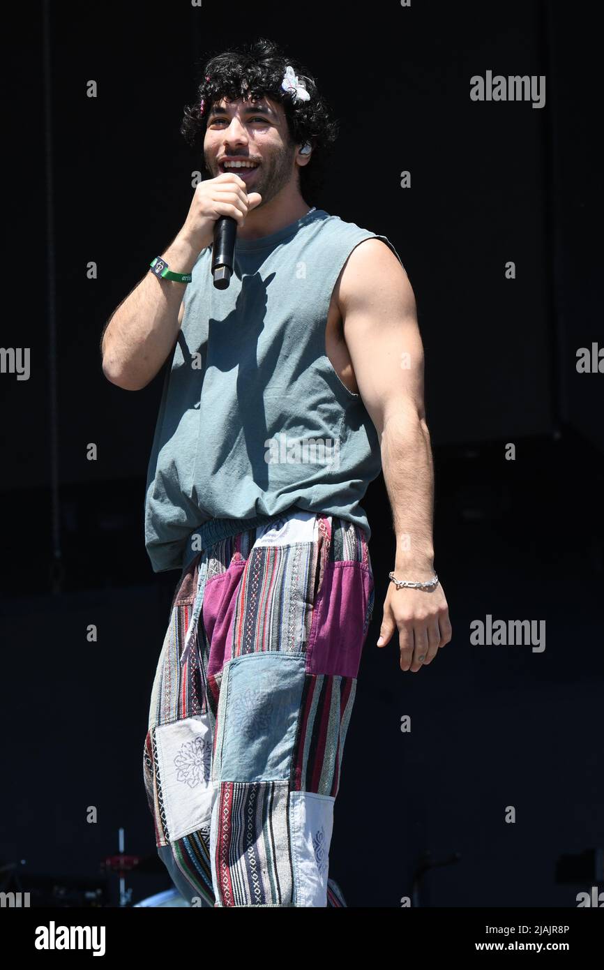 Singer Isaac Pech is shown performing on stage during a live concert ...