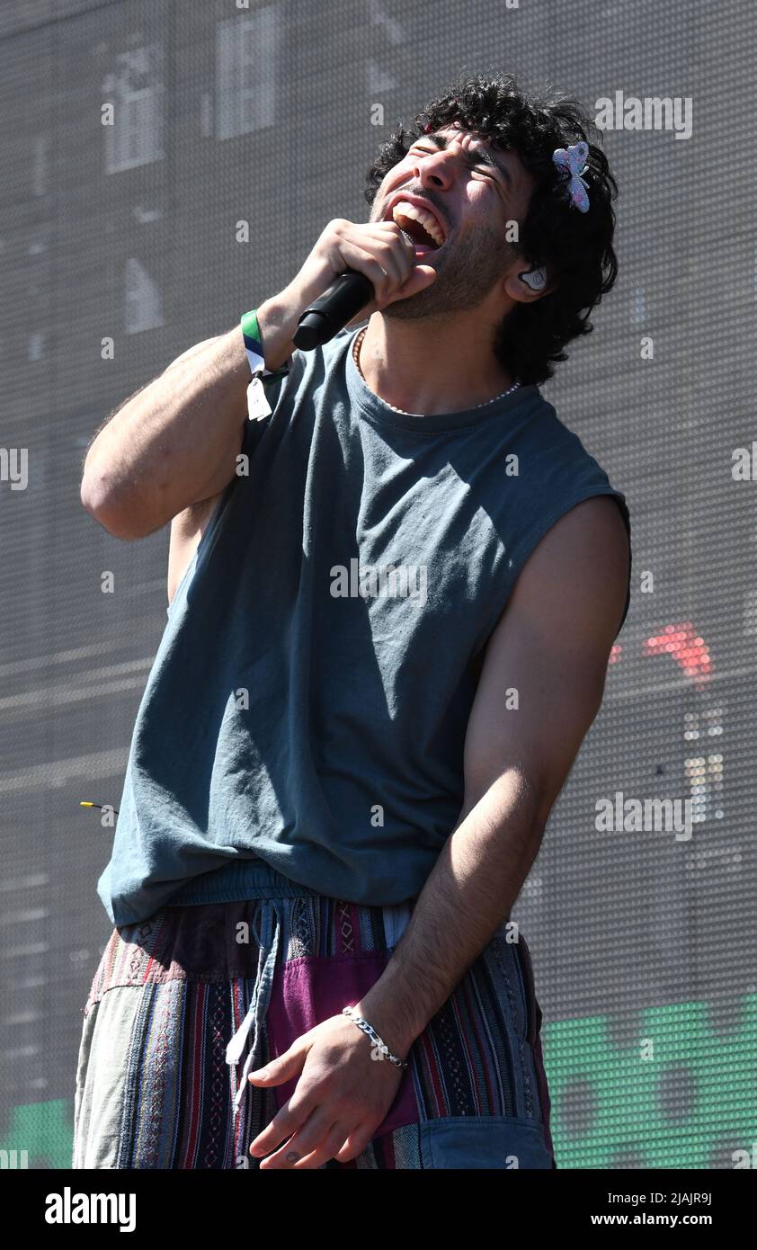 Singer Isaac Pech is shown performing on stage during a live concert ...