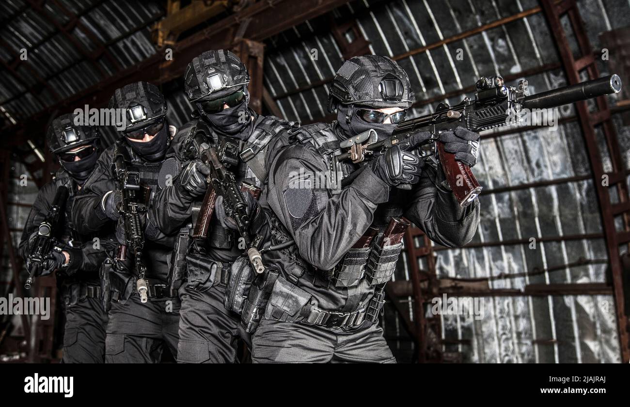 Police tactical group moving in stack formation behind squad leader in ...