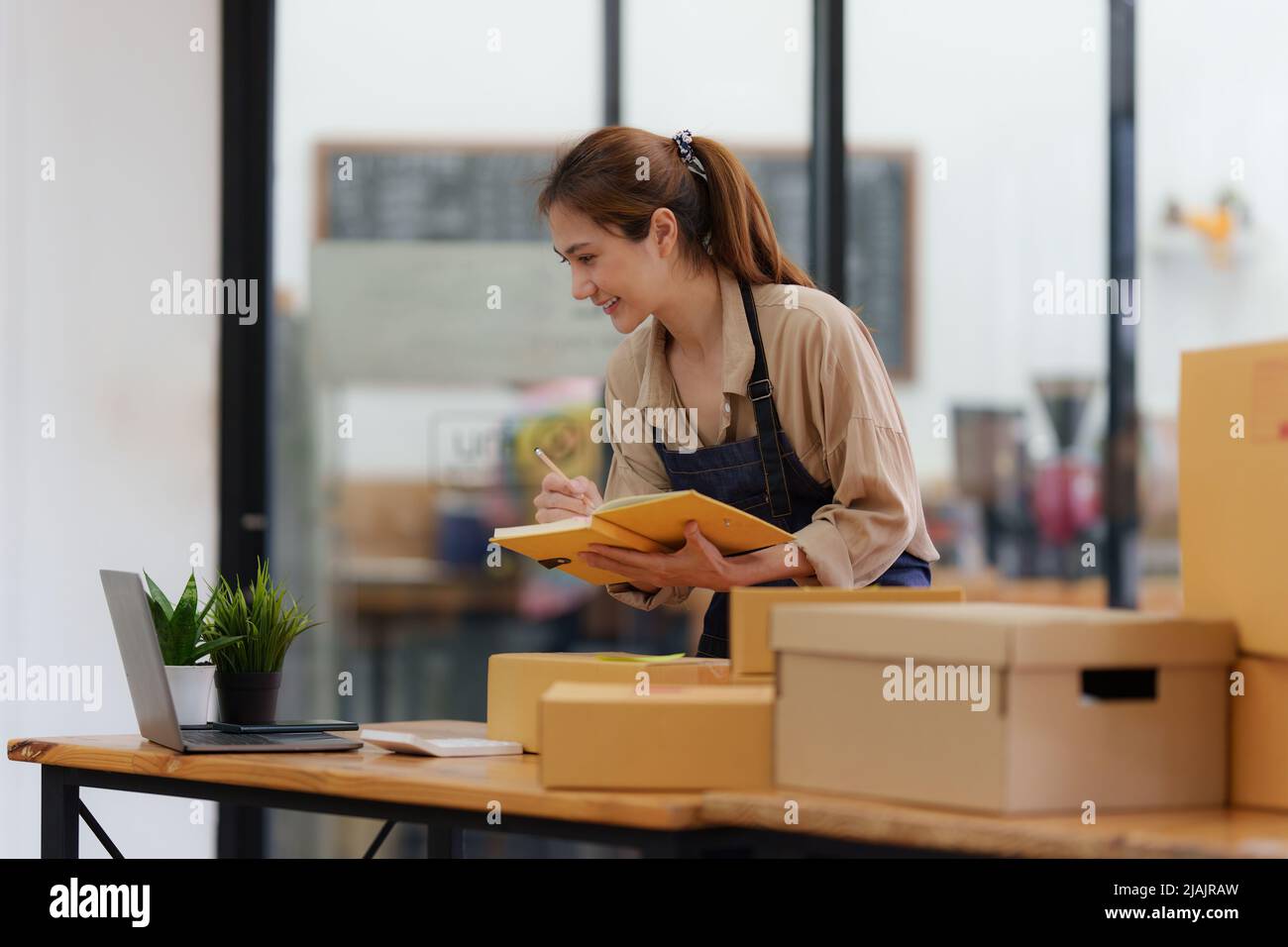 A portrait of Asian woman, e-commerce employee freelance with parcel ...