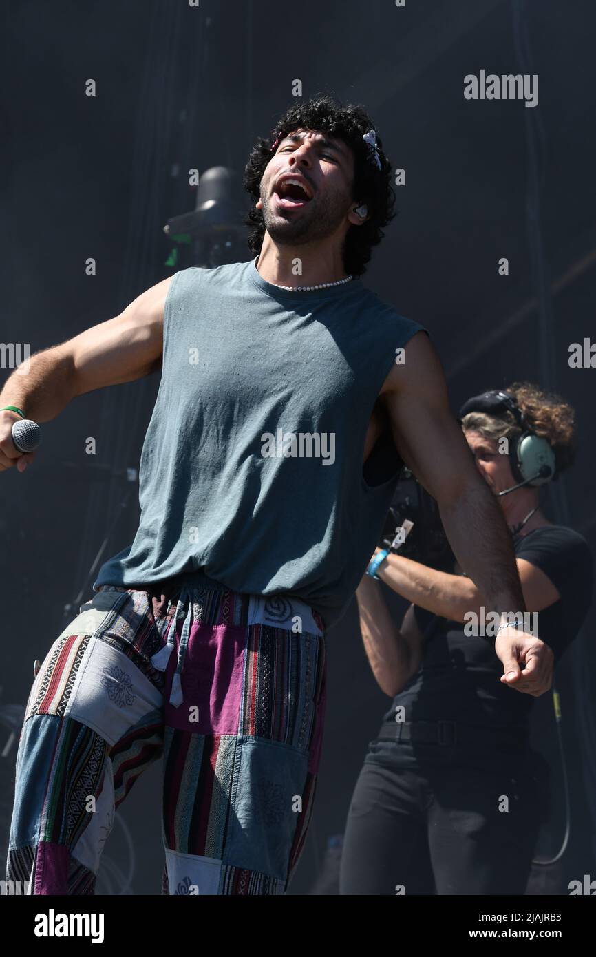 Singer Isaac Pech is shown performing on stage during a live concert ...