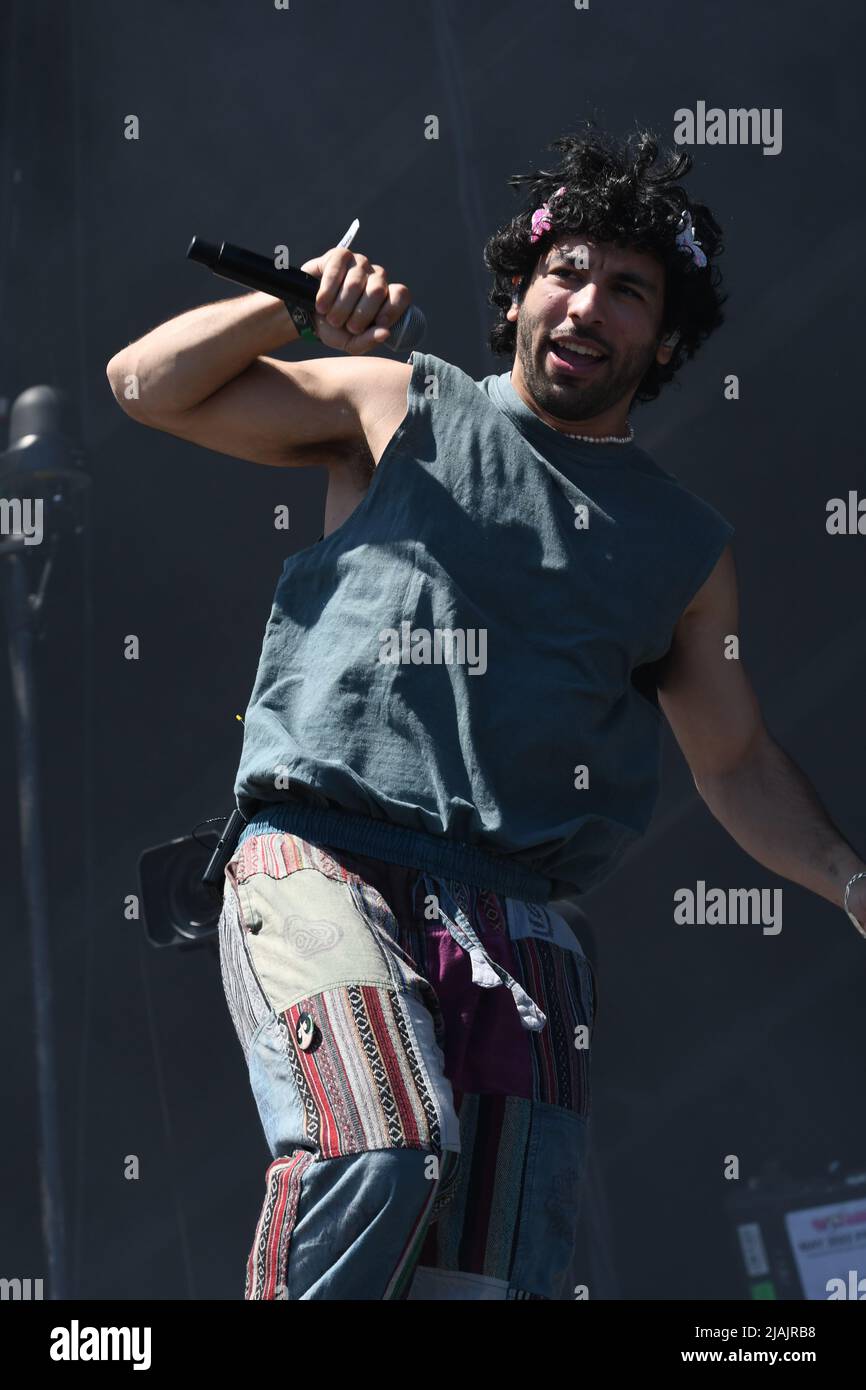 Singer Isaac Pech is shown performing on stage during a live concert ...