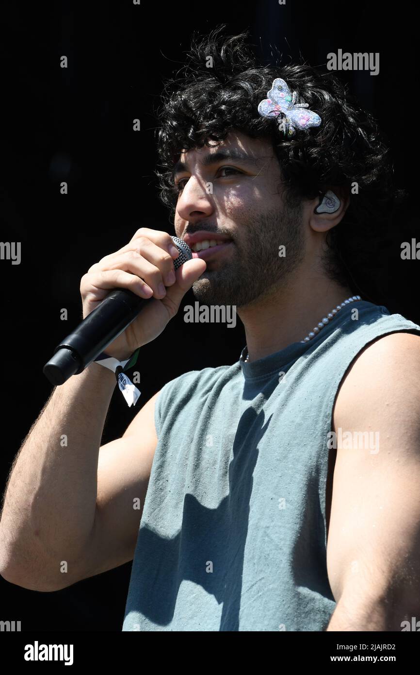 Singer Isaac Pech is shown performing on stage during a live concert ...