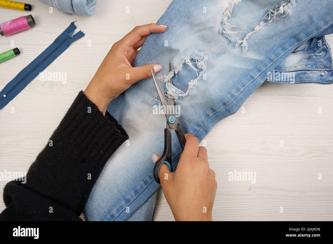 cutting youth clothing, use of scissors in textiles, dressmaker working ...