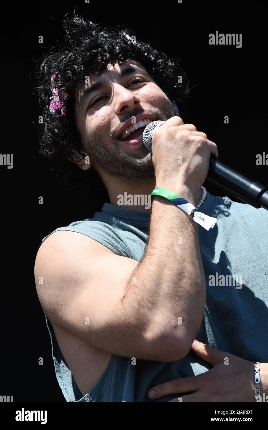 Singer Isaac Pech is shown performing on stage during a live concert ...