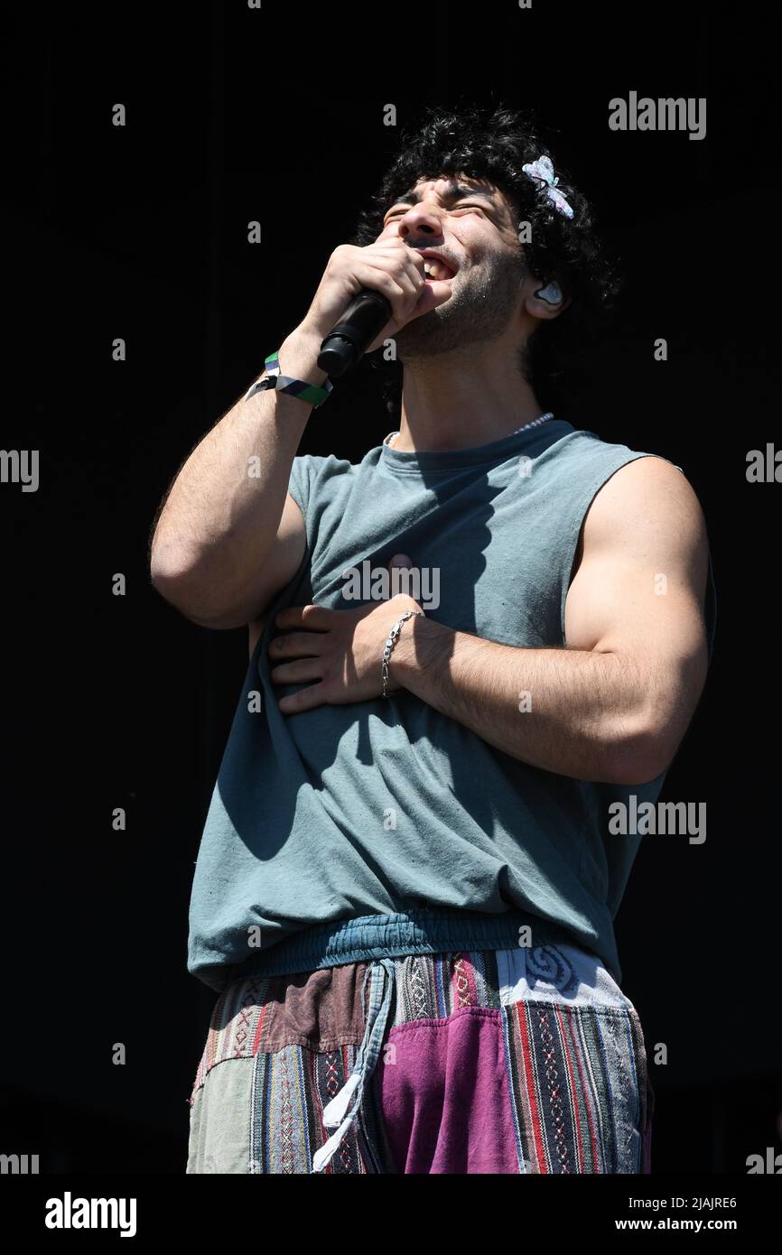 Singer Isaac Pech is shown performing on stage during a live concert ...