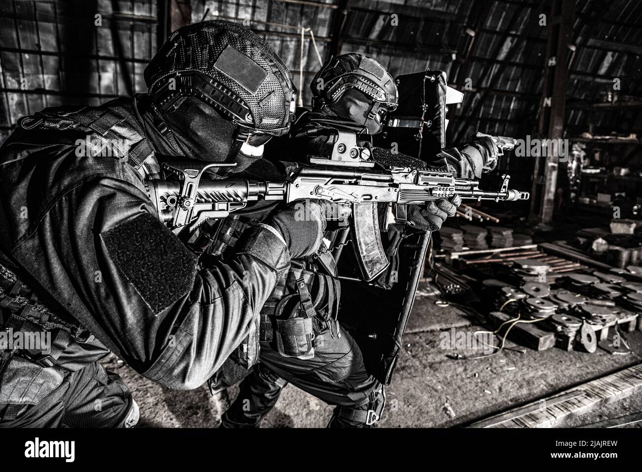 Police special reaction team aiming guns while moving forward under ...