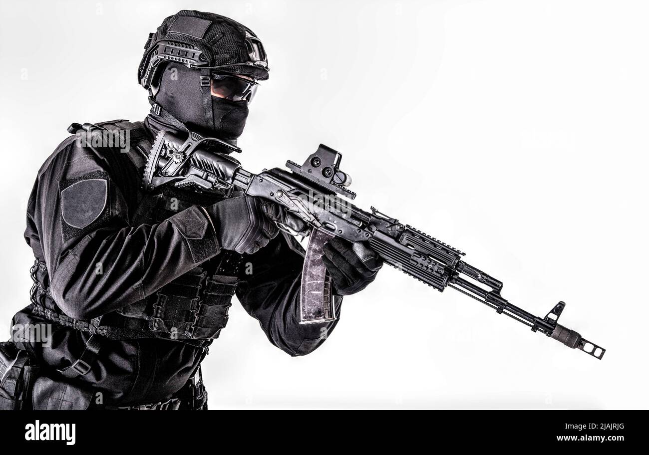 Studio portrait of police special reaction team member black uniform ...