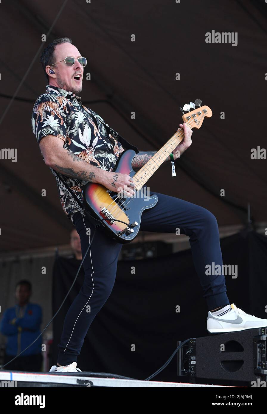 Bass guitarist and singer Scott Shriner is shown performing on stage ...