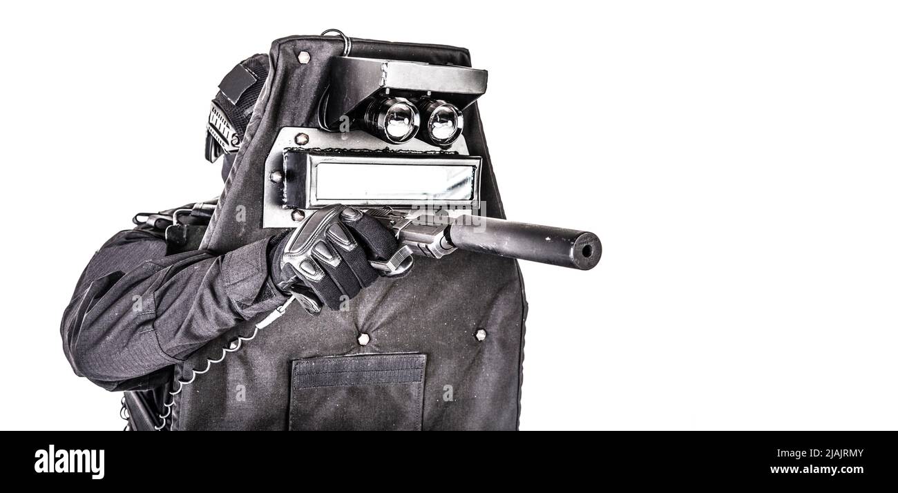 SWAT team fighter hiding behind ballistic shield and aiming pistol ...