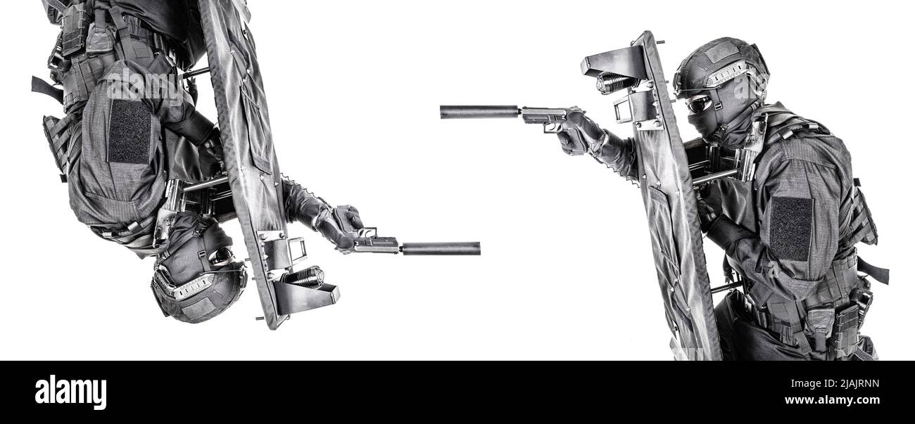 SWAT team fighter hiding behind ballistic shield and aiming pistol ...