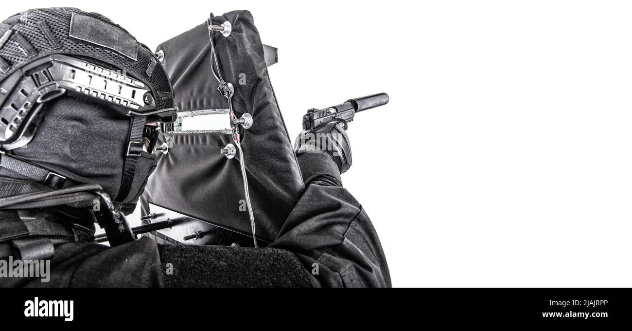 SWAT team fighter hiding behind ballistic shield and aiming pistol ...