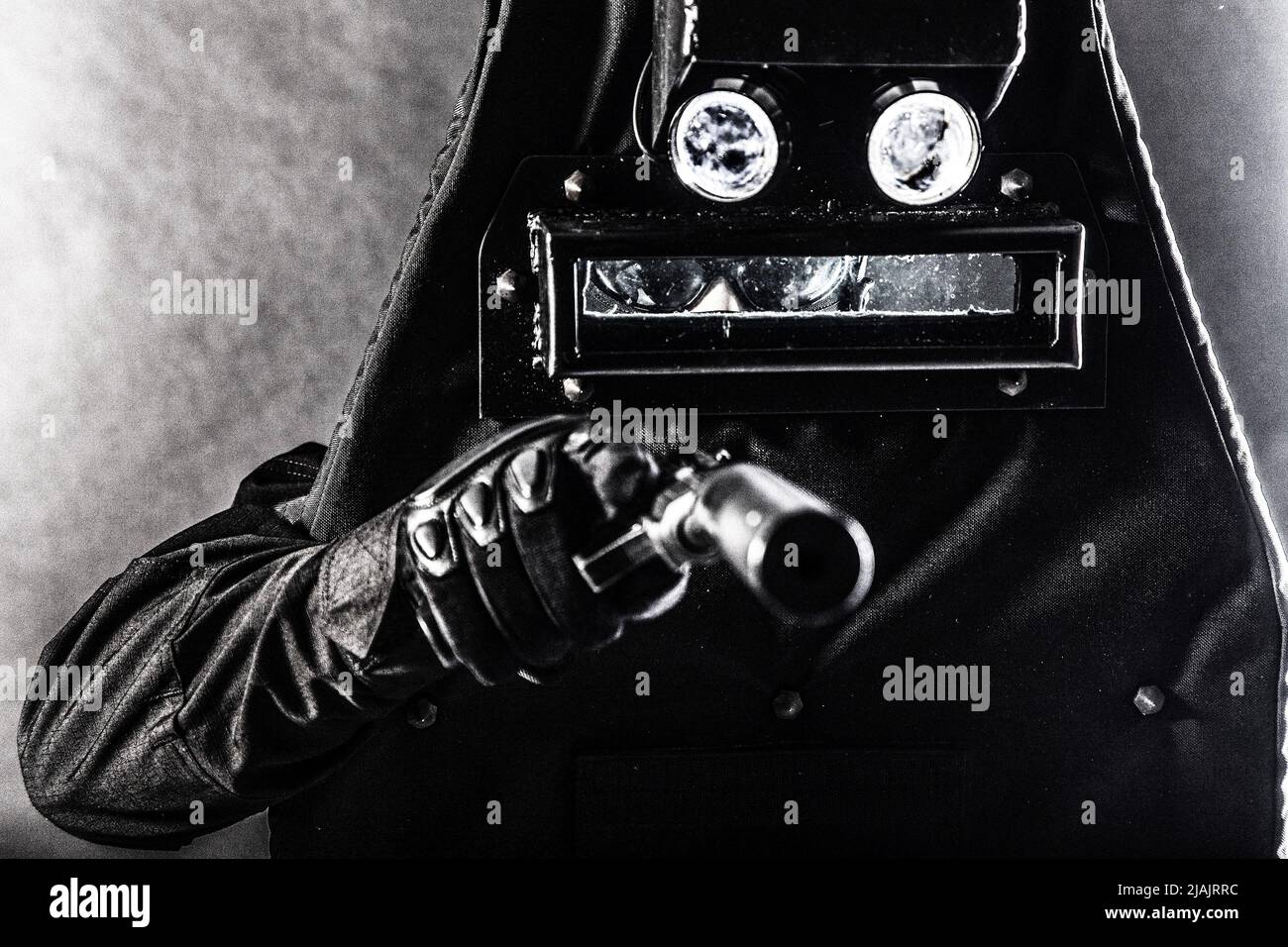 SWAT fighter aiming pistol while hiding behind ballistic shield Stock ...