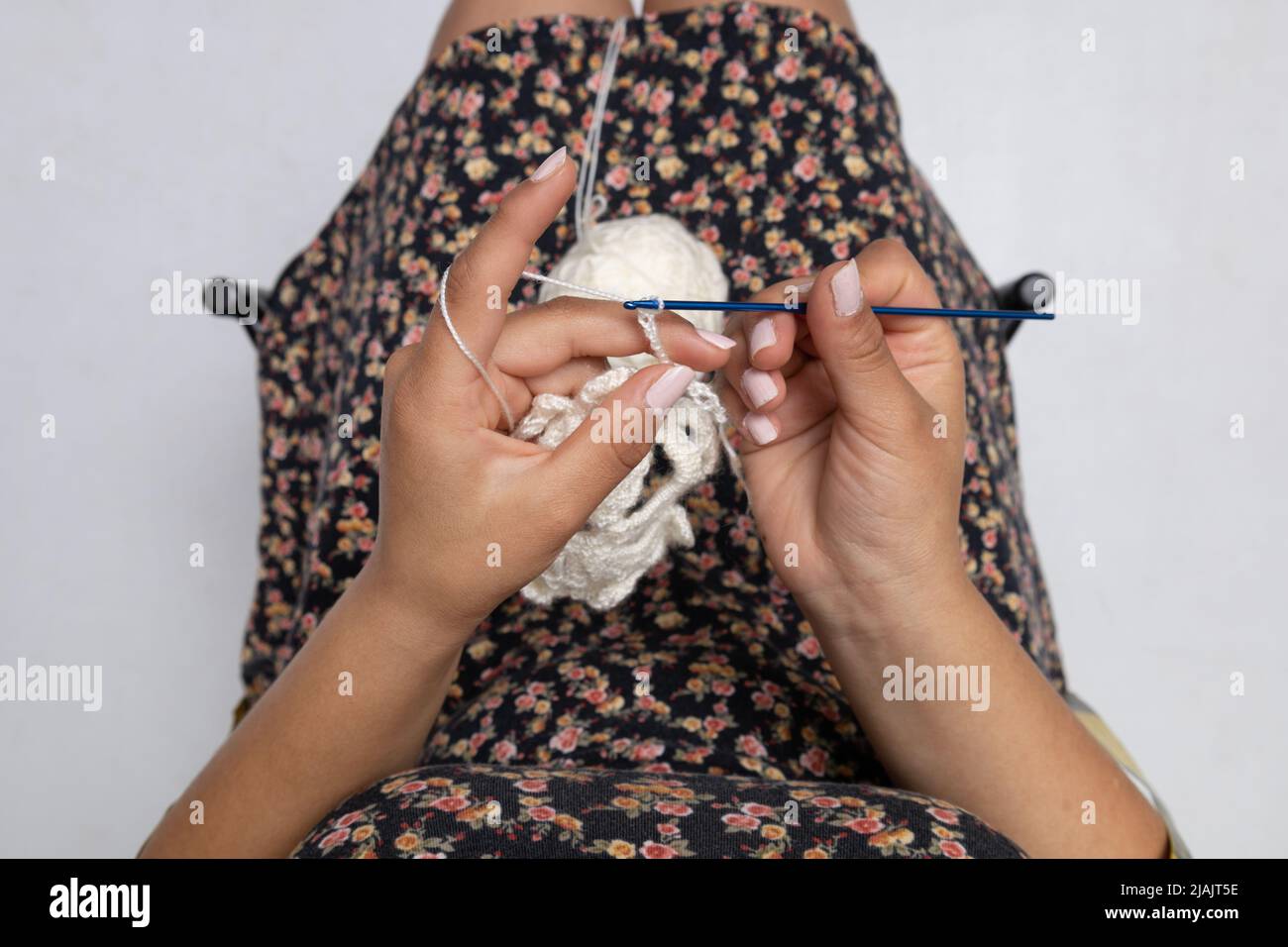 hands knitting with crochet and wool, craft as a hobby in studio ...