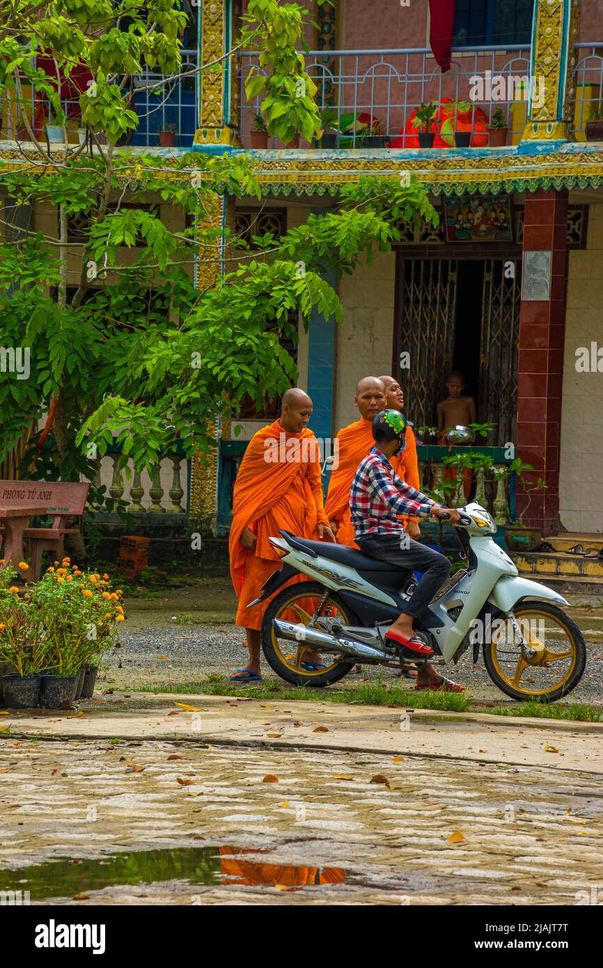 An Giang Province, Vietnam - May 01, 2022 : Khmer monks riding scooter on rural road in Mekong ...