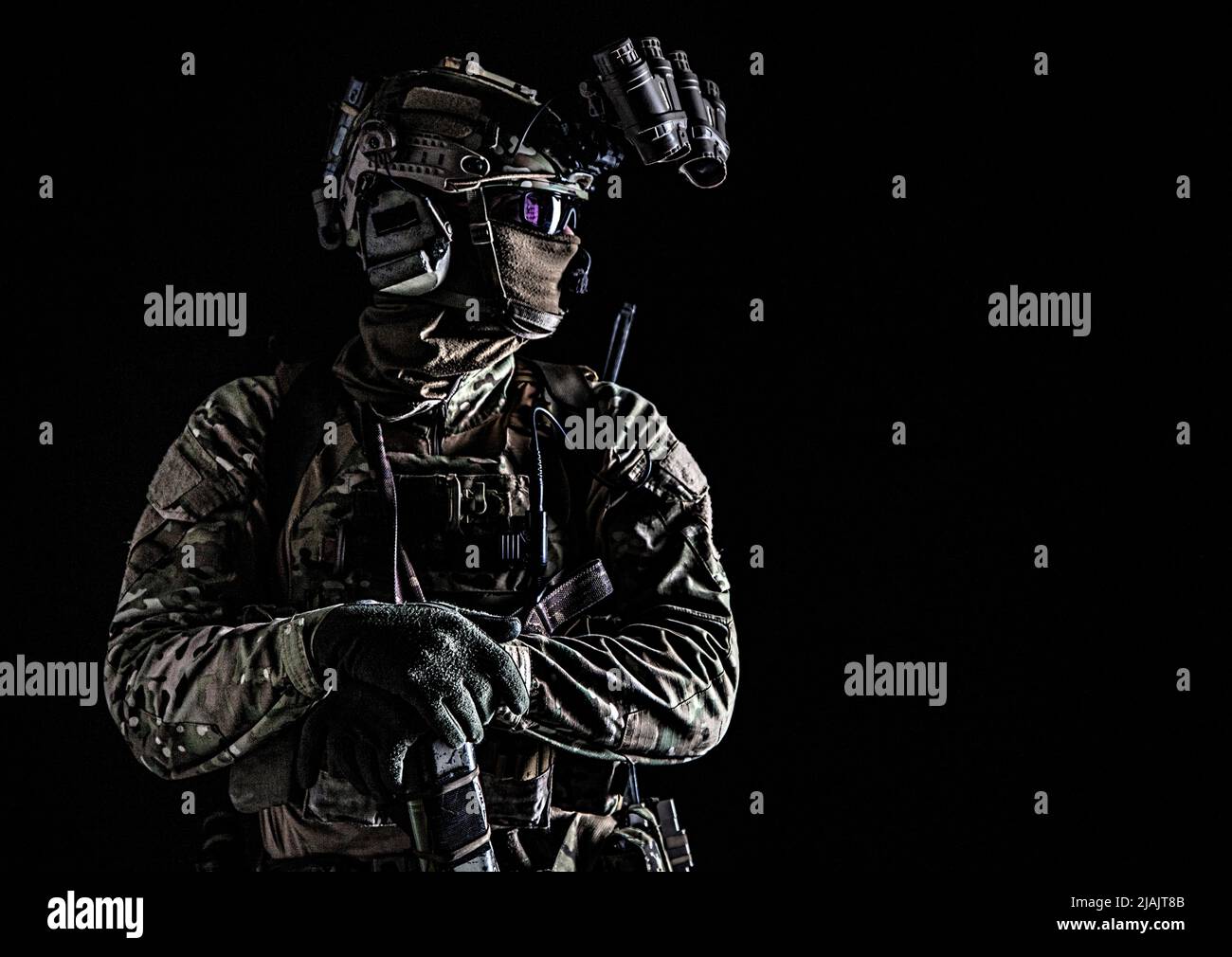 Studio portrait of a special forces member wearing night vision goggles ...