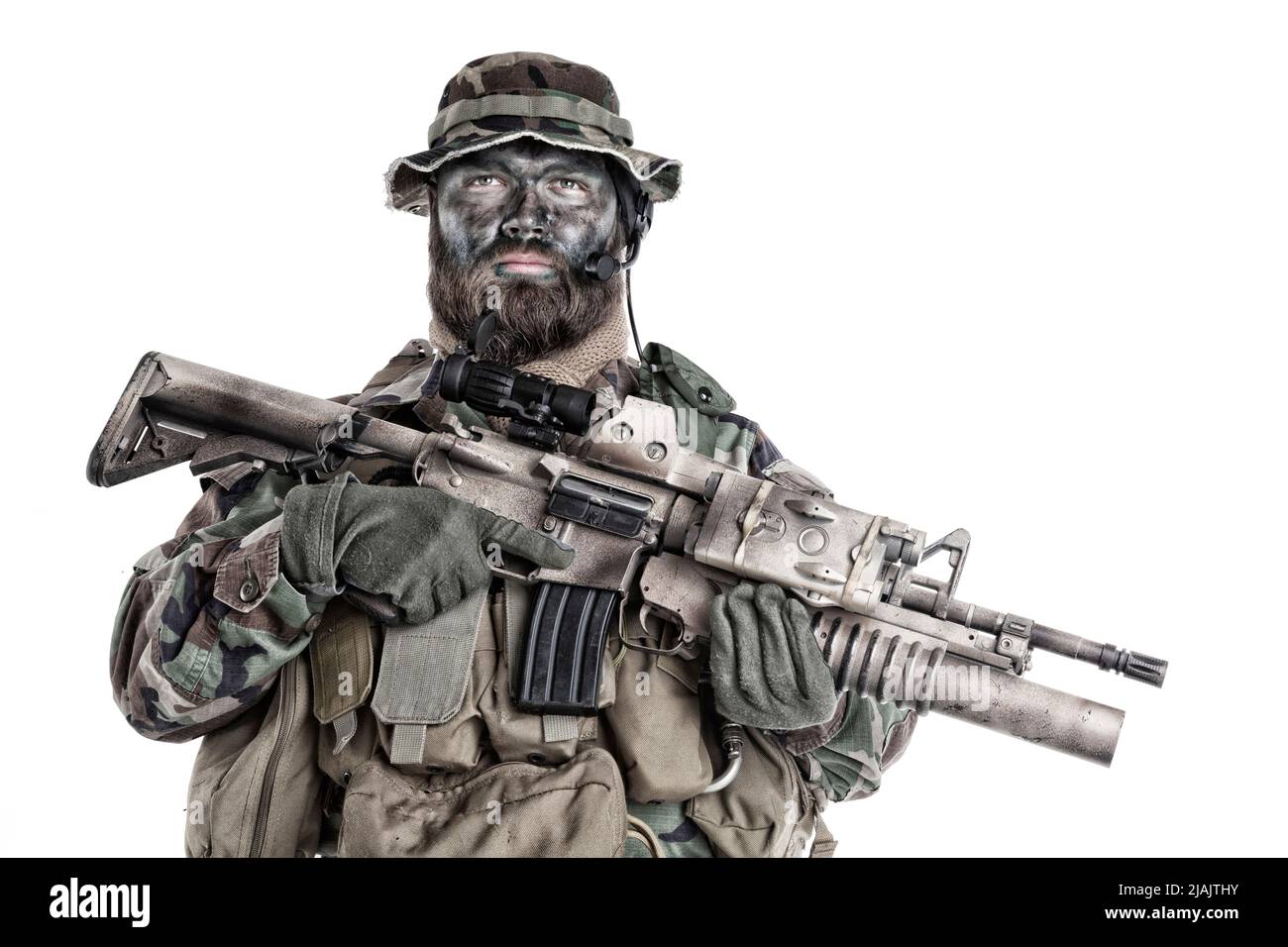 Commando fighter holding assault rifle with grenade launcher, studio ...