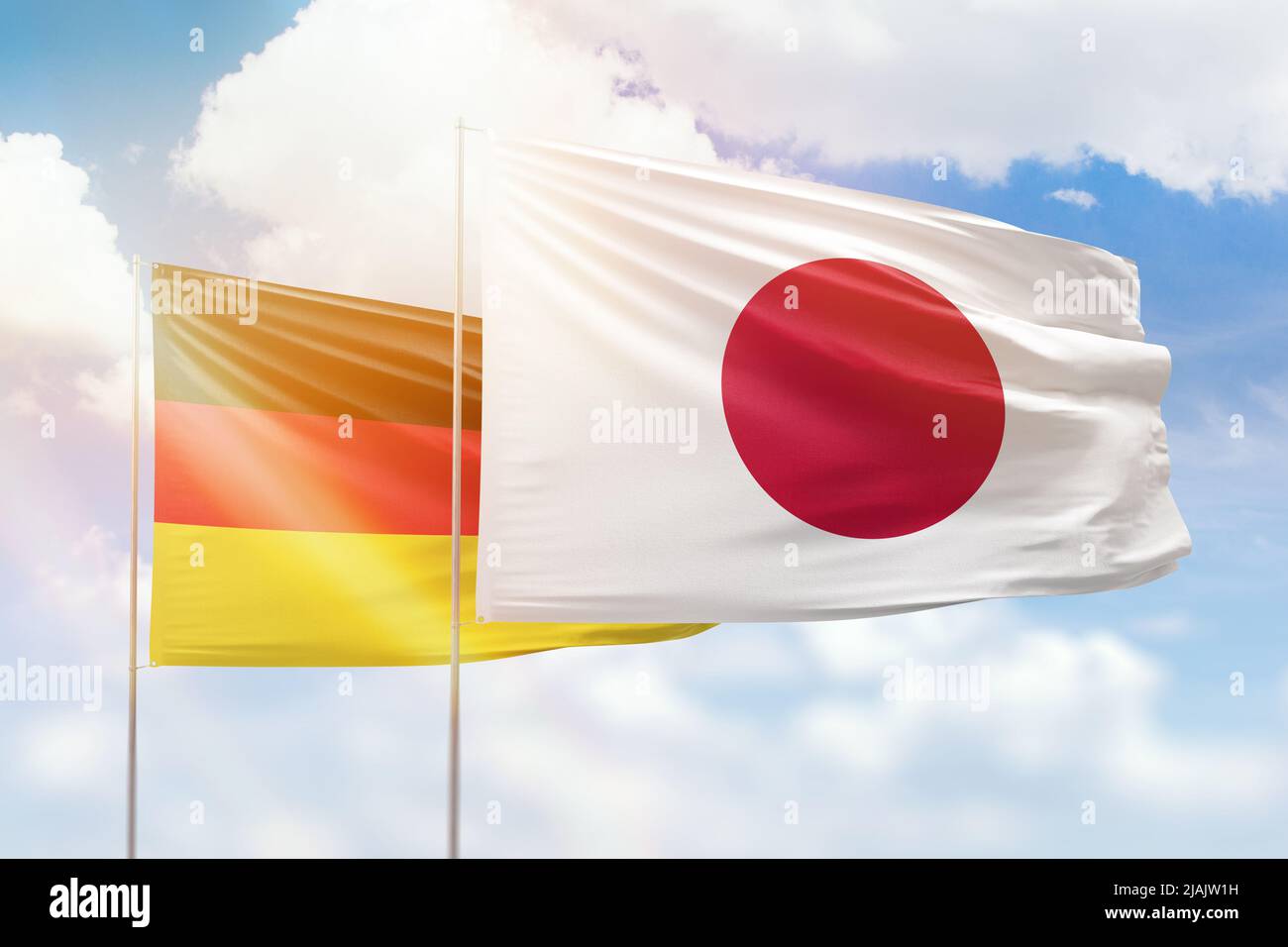 Sunny blue sky and flags of japan and germany Stock Photo - Alamy